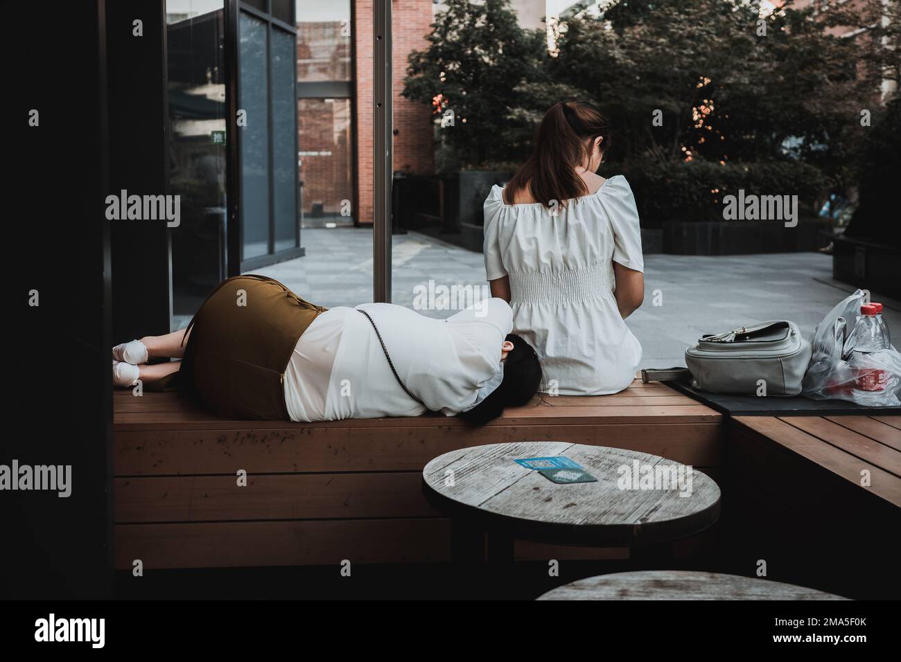 A female having a rest on the bench Stock Photo - Alamy