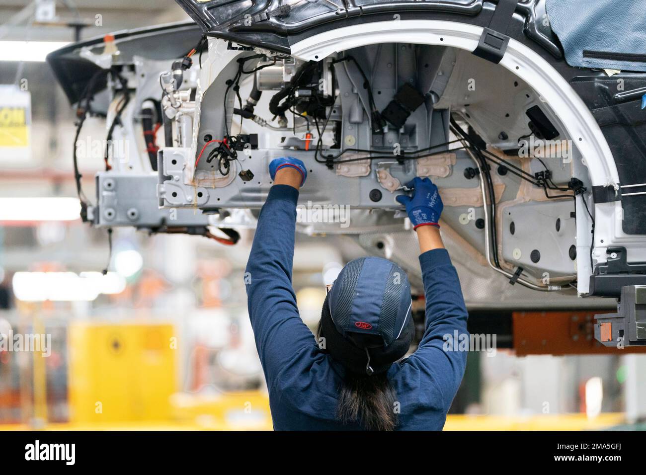 An employee works on a car on the assembly line at the BMW Spartanburg ...