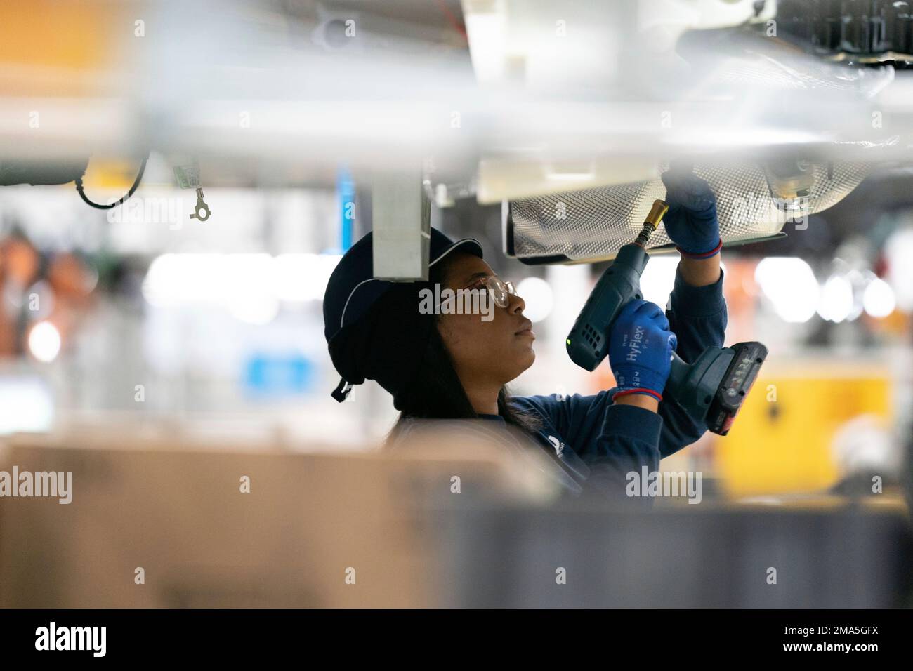 An employee works on a car on the assembly line at the BMW Spartanburg ...