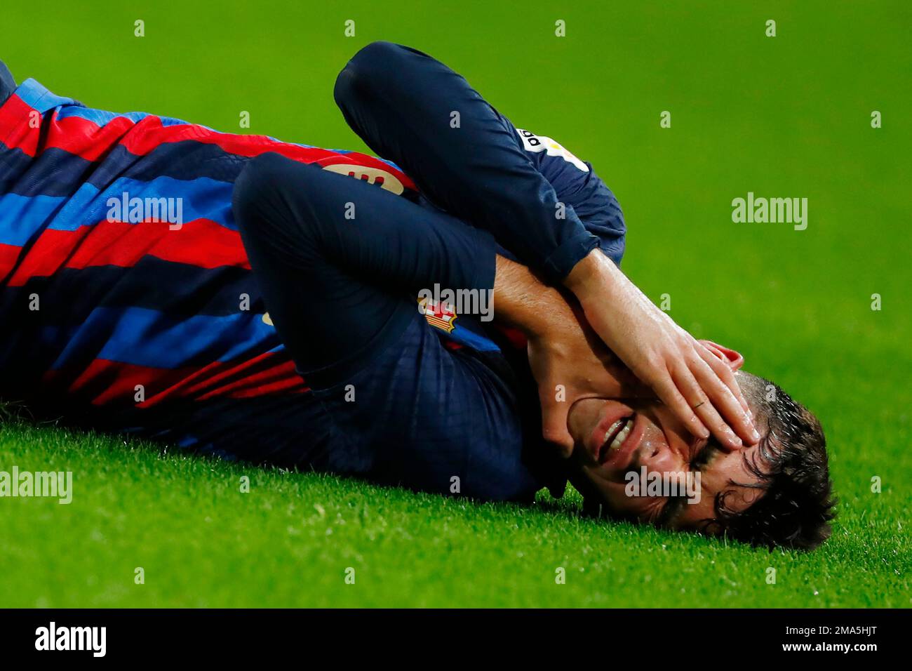 Barcelona's Pedri lies in pain on the pitch during the Spanish La Liga ...