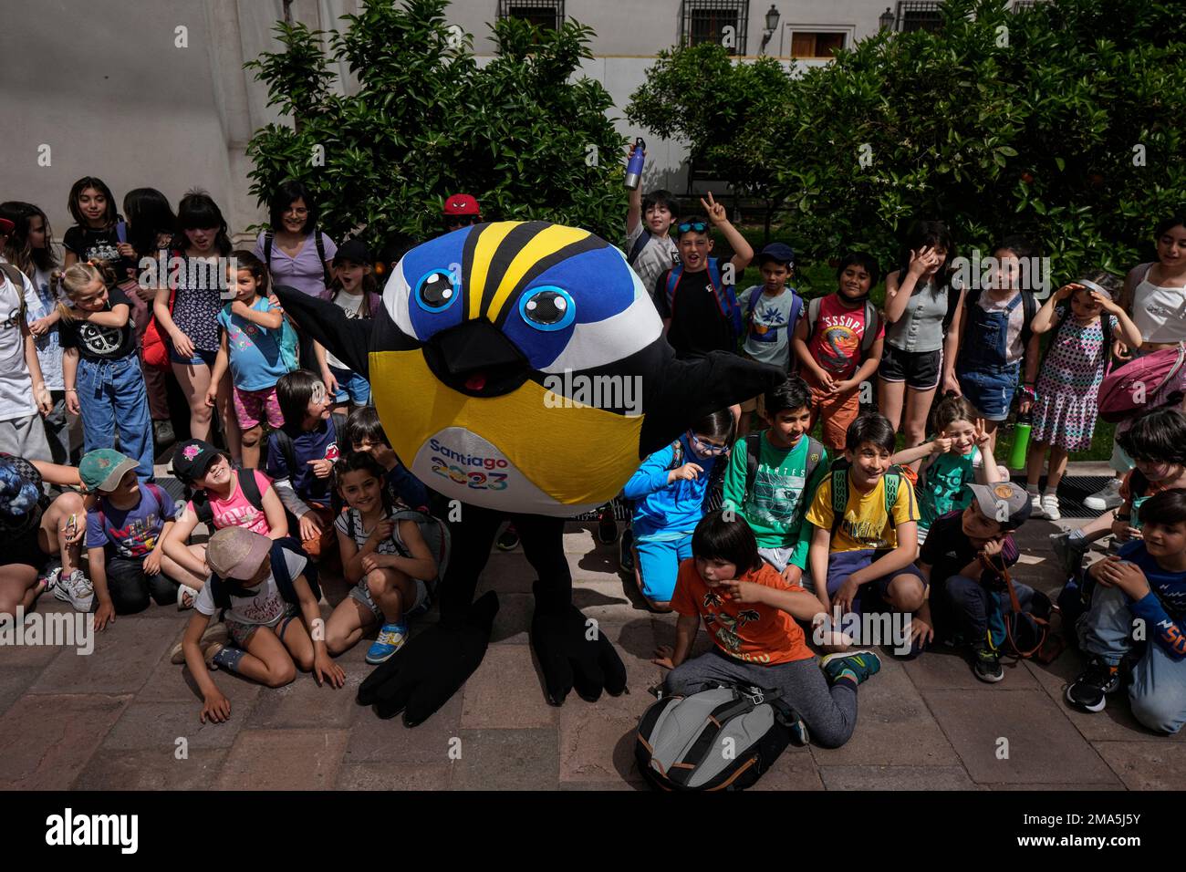 The Pan American Games mascot Fiu, a bird, poses for pictures with ...