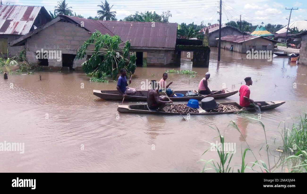 People paddle their canoes along flooded residential streets after a ...