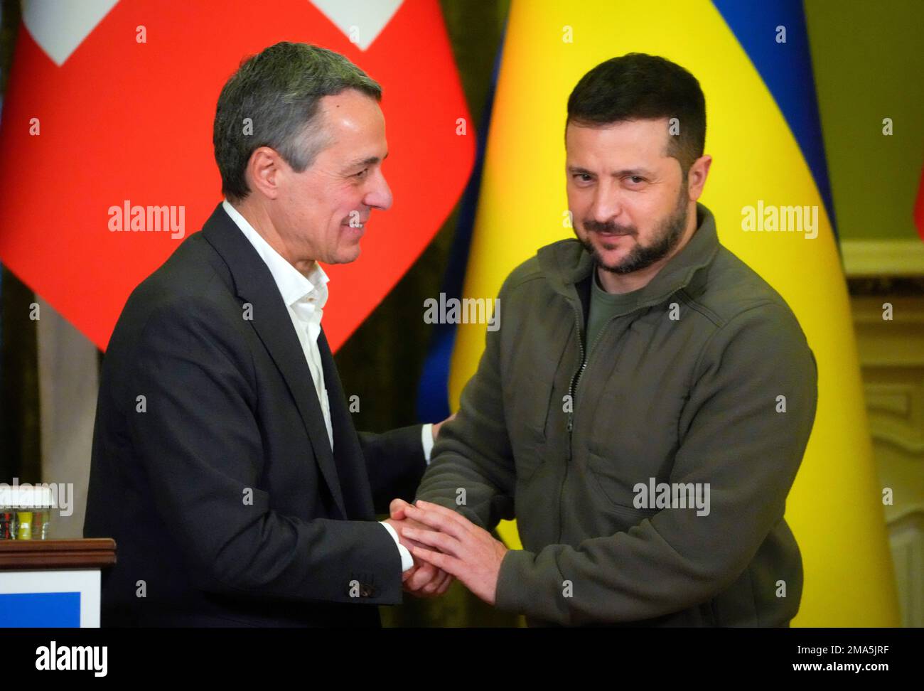 Ukrainian President Volodymyr Zelenskyy, right, shakes hands with Swiss ...