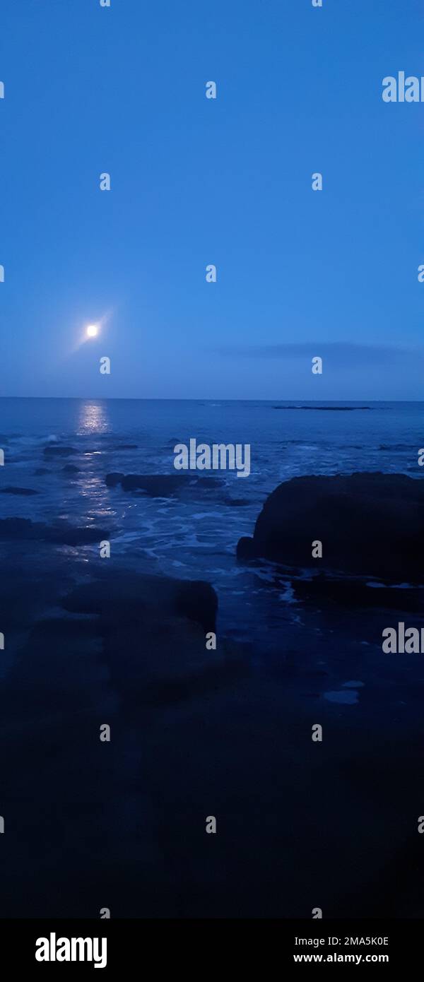 An aerial view of sea waves breaking beach during sunset Stock Photo ...