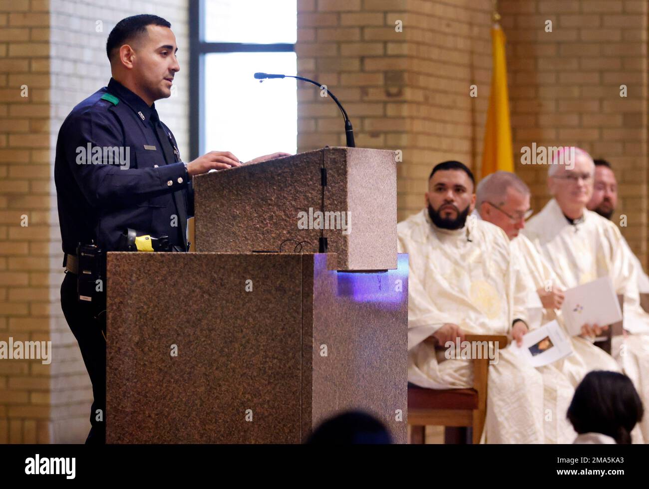With the clergy looking on, Dallas Police Officer Joshua Arellano ...