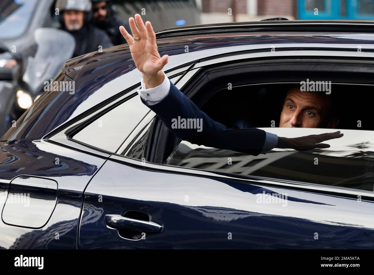 French President Emmanuel Macron waves as he leaves in a car after a ...