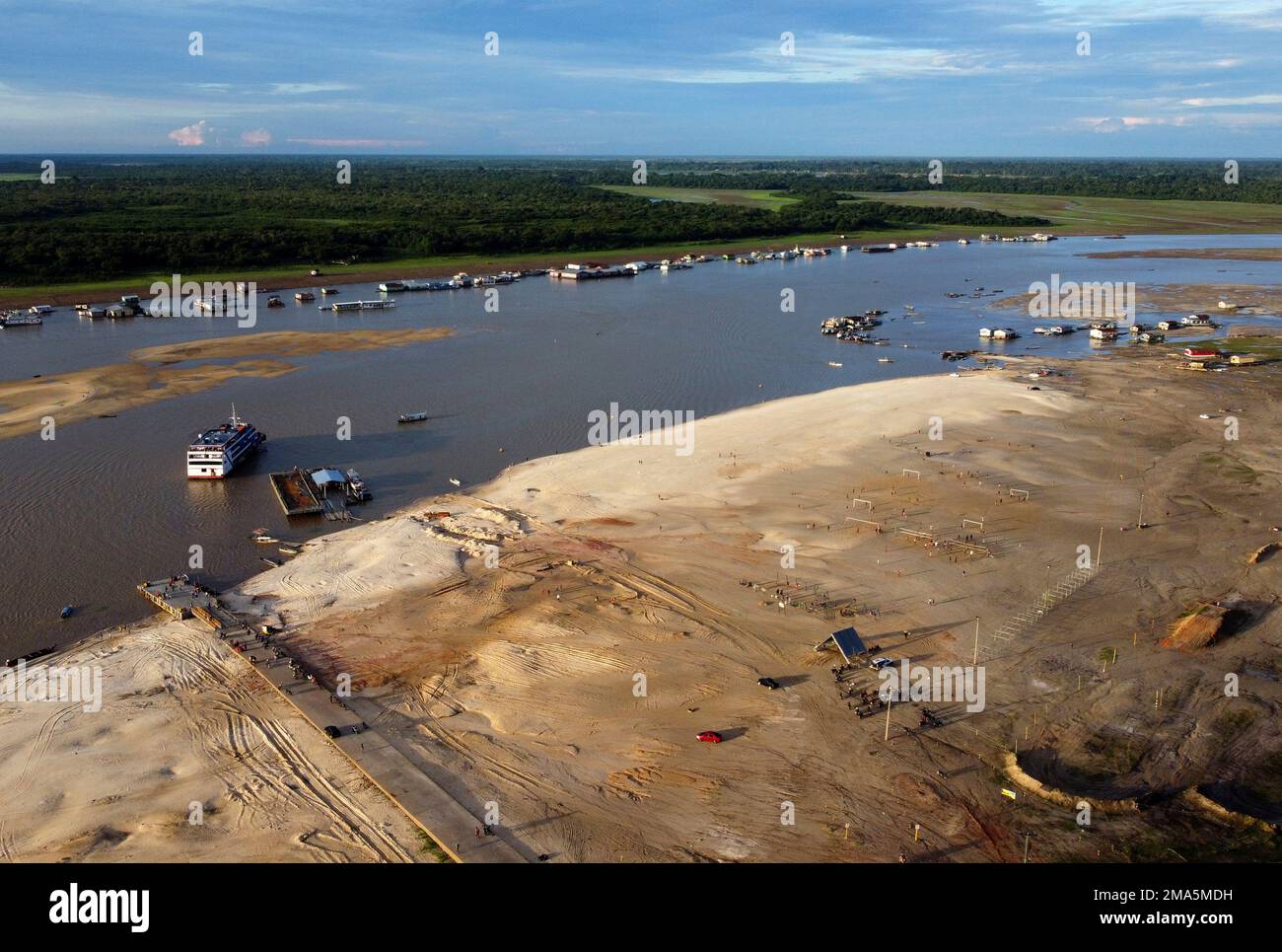A boat dock sits amid drought-impacted land near the Solimões River, in ...