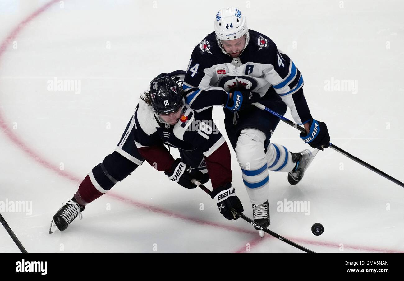 Colorado Avalanche center Alex Newhook, left, vies for control of the ...