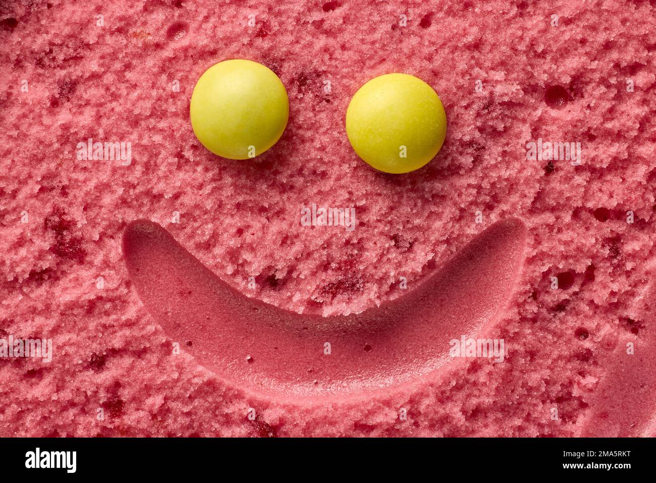 funny smiling ice cream face, raspberry sorbet and yellow round candies ...