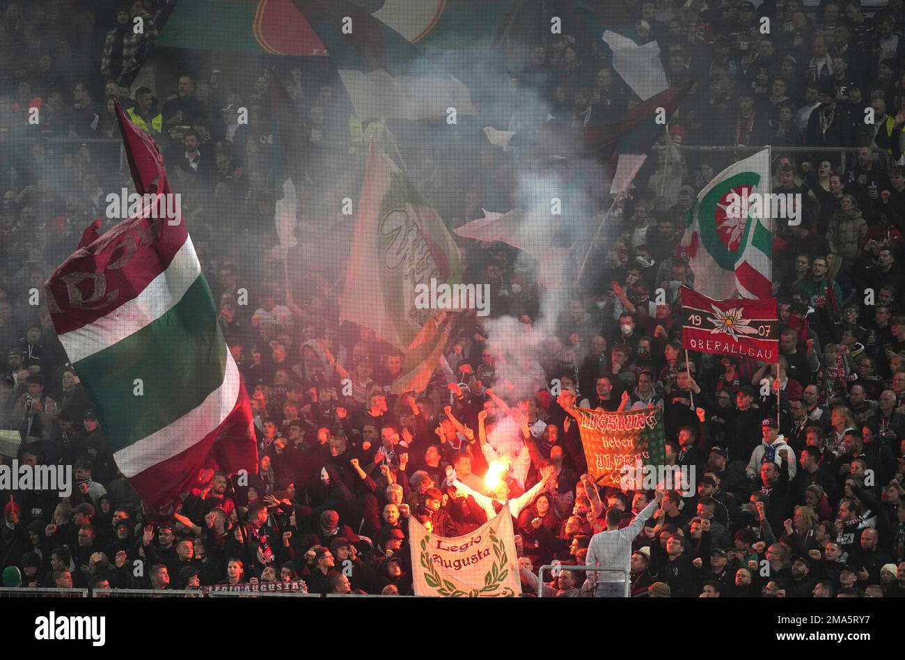 Fans burn flares and hold flags during the German soccer cup, DFB Pokal ...