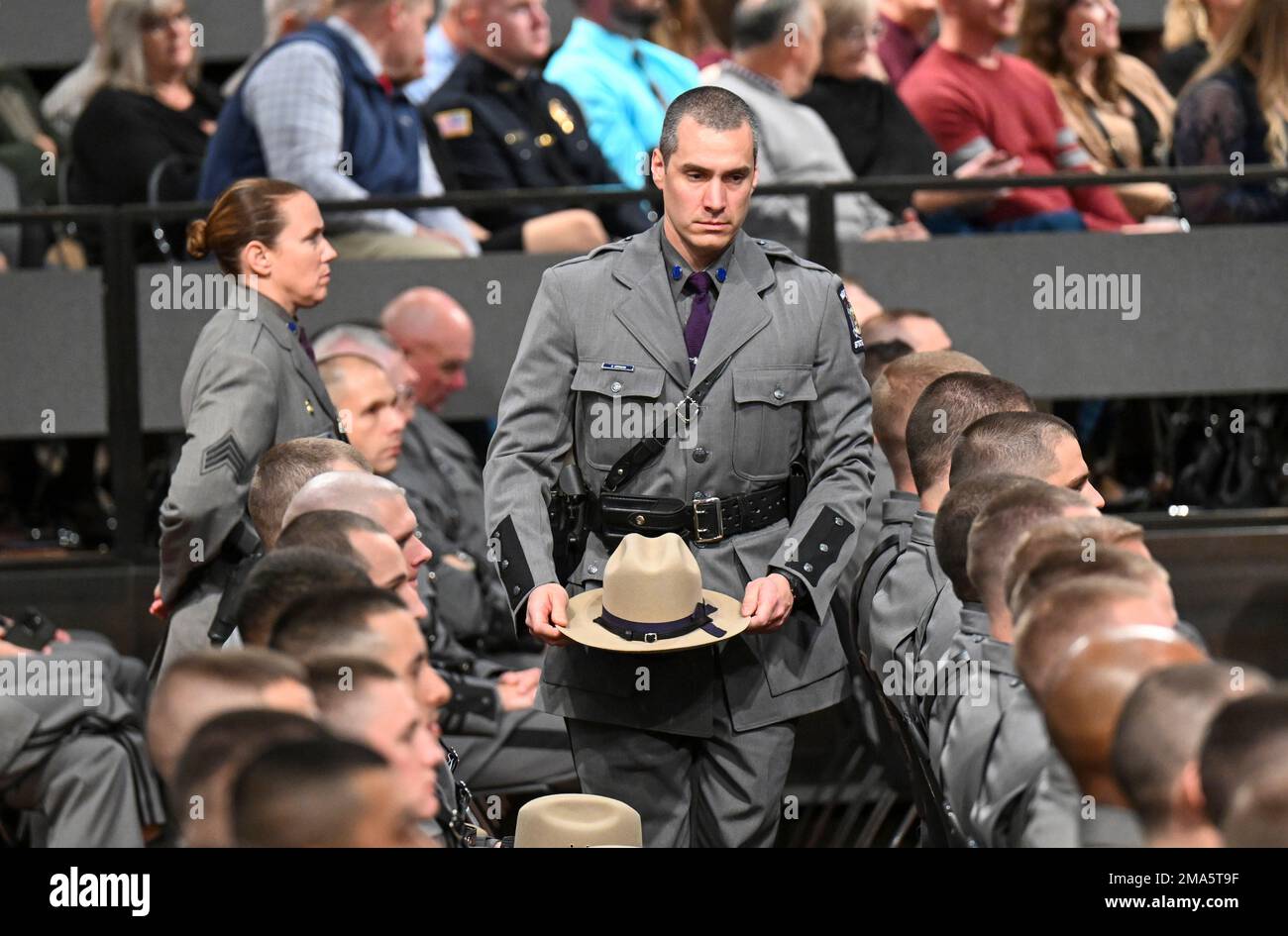 A New York State Police graduate returns to his seat during a ...