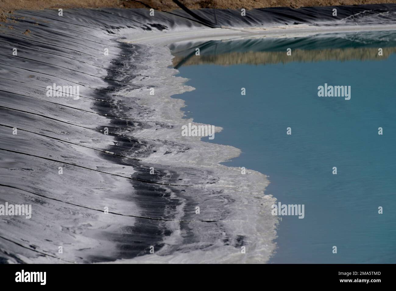Salt lines a brine evaporation pond at Albemarle Corp.'s Silver Peak ...