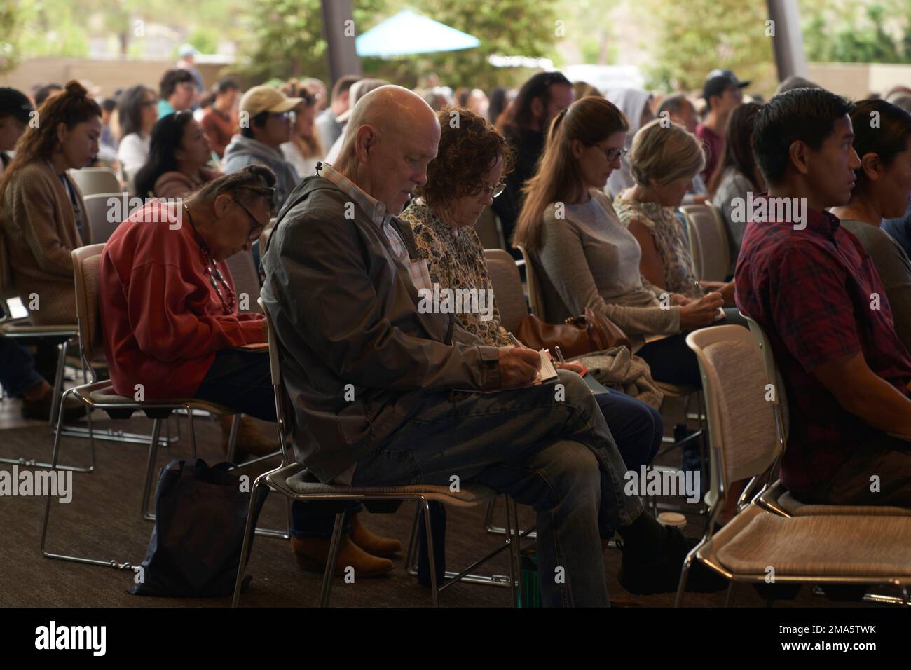 Congregants take notes as Pastor Andy Wood gives a sermon on Sunday ...