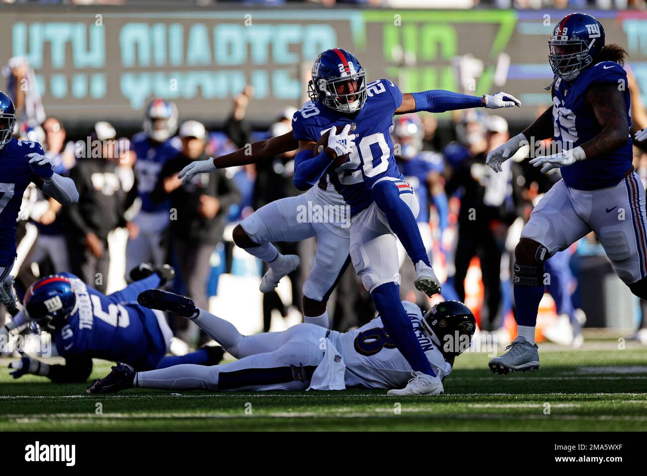 New York Giants safety Julian Love (20) returns an interception over ...