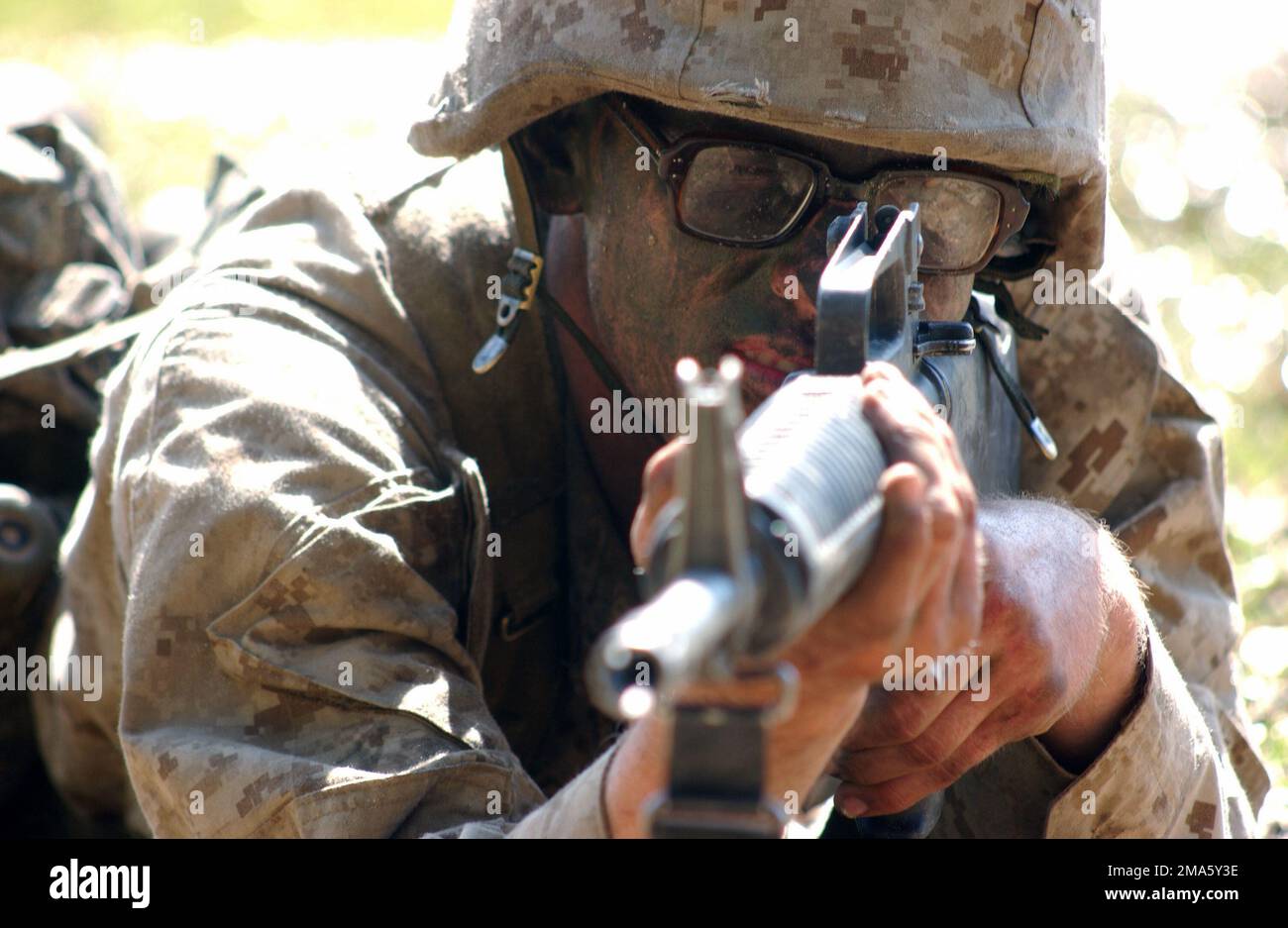 A US Marine Corps (USMC) Recruit armed with at 5.56mm M16A2 rifle, lies ...