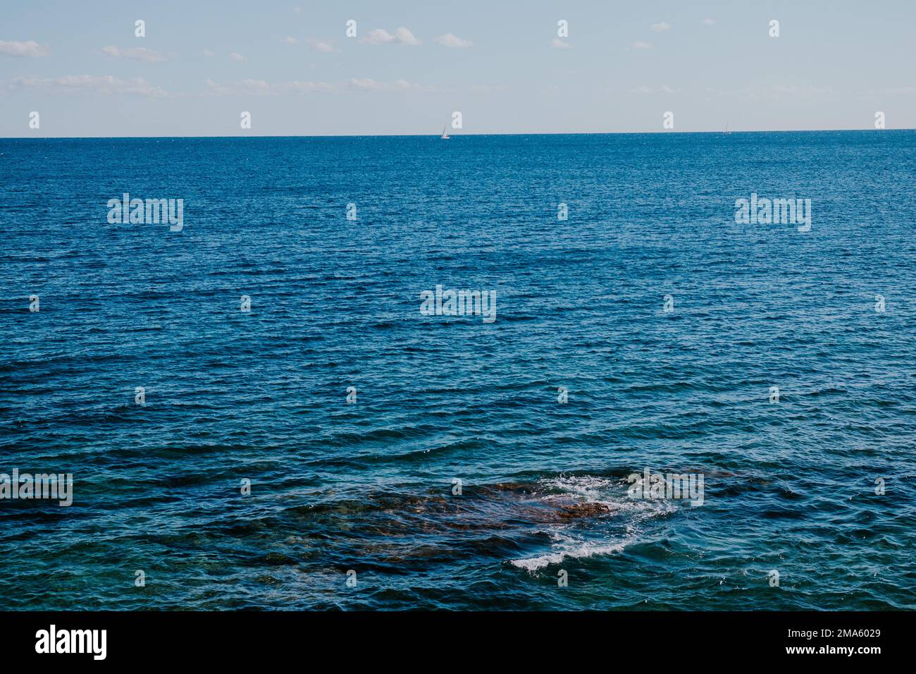 Summer coastline near an island on the deep blue ocean Stock Photo - Alamy