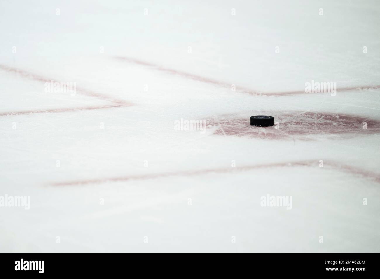 An NHL puck is sitting on a face-off circle during the first period of ...
