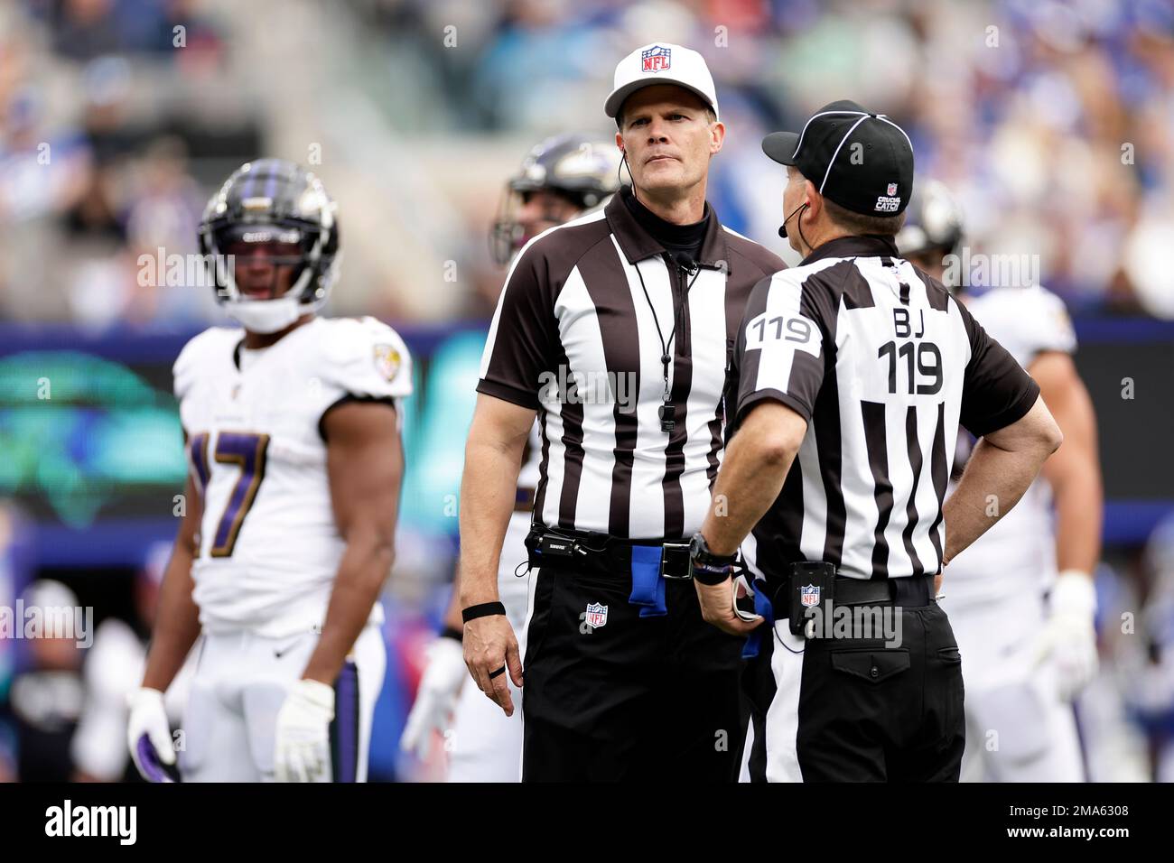 Referee Clay Martin (19) talks with back judge Greg Wilson (119) during ...