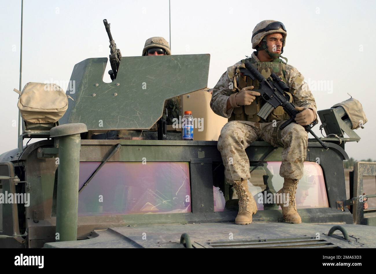 US Marine Corps (USMC) Corporal Sean Adcox (left), mans the 7.62mm ...