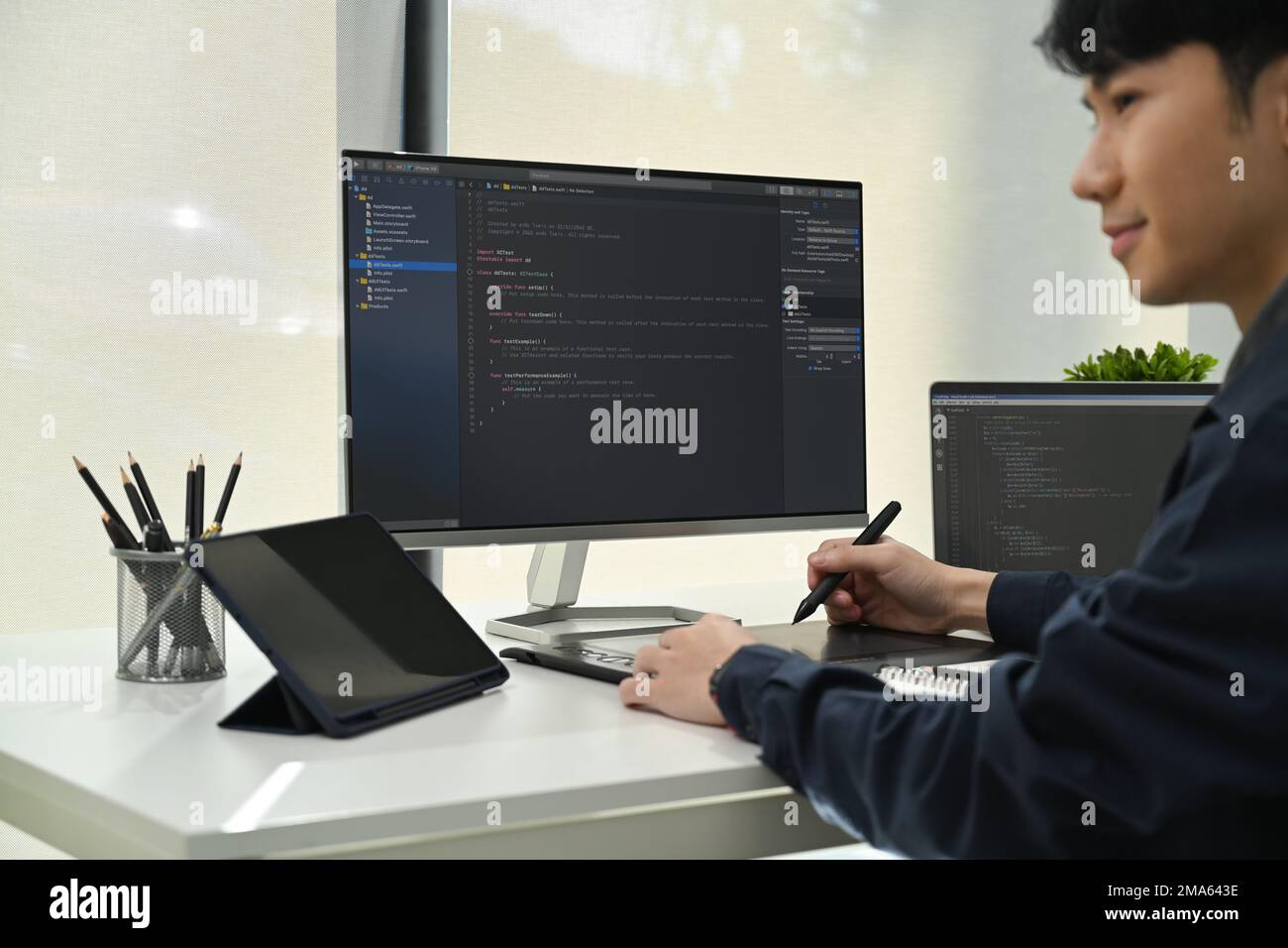 Side View Of Male Programmer Working On Laptop To Check Coding In Bugging System In It Office