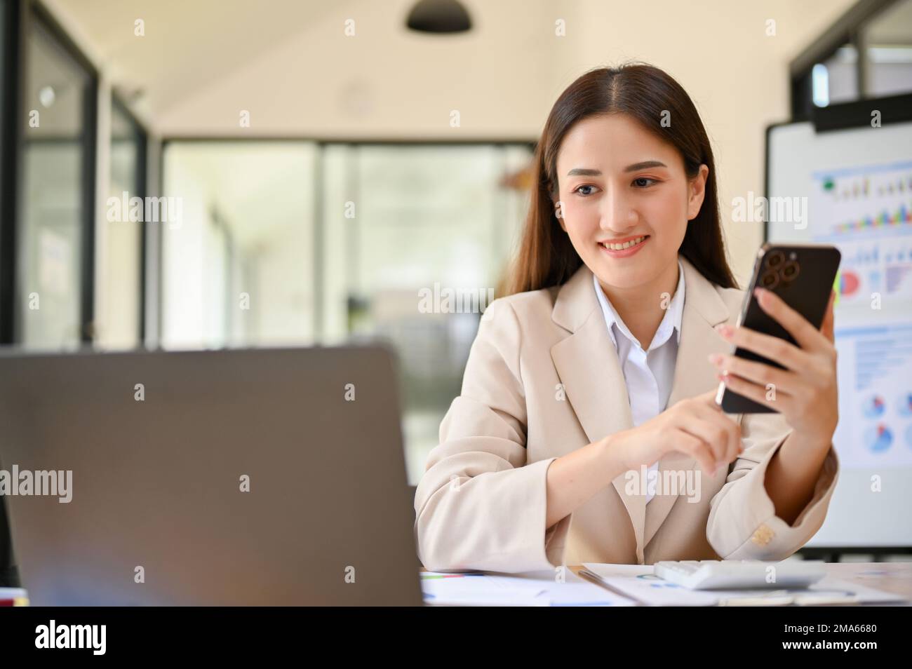 Charming millennial Asian businesswoman or female financial worker ...