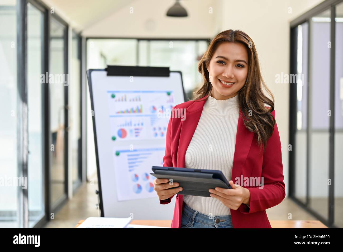 Confident and successful millennial Asian businesswoman or female boss ...
