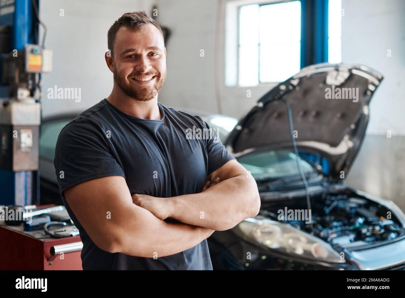 Looking for a trustworthy mechanic Hes your guy. a mechanic posing with ...