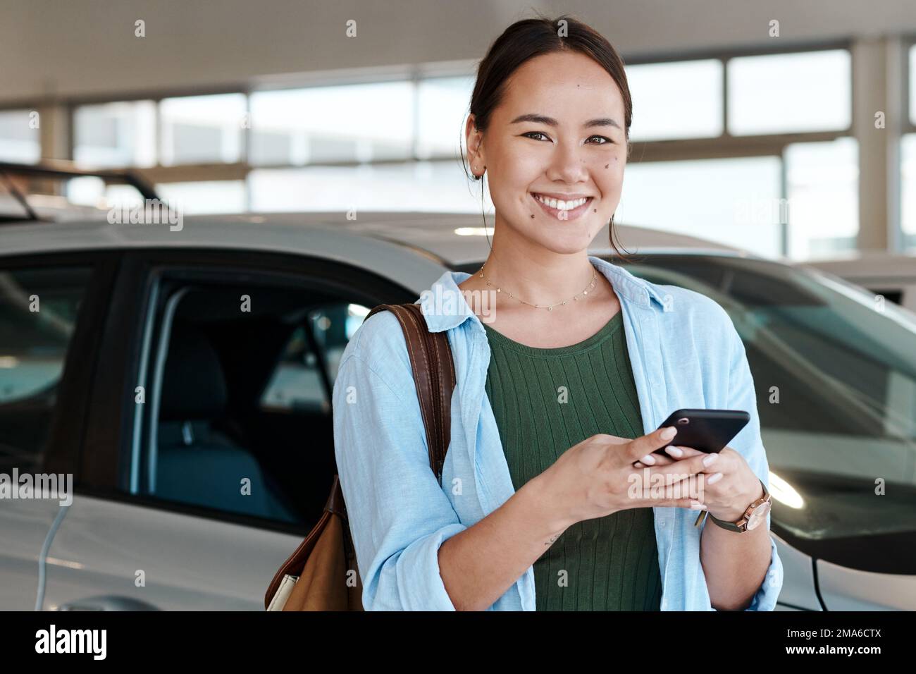 Ive never been more excited. a young woman using her smartphone to send ...