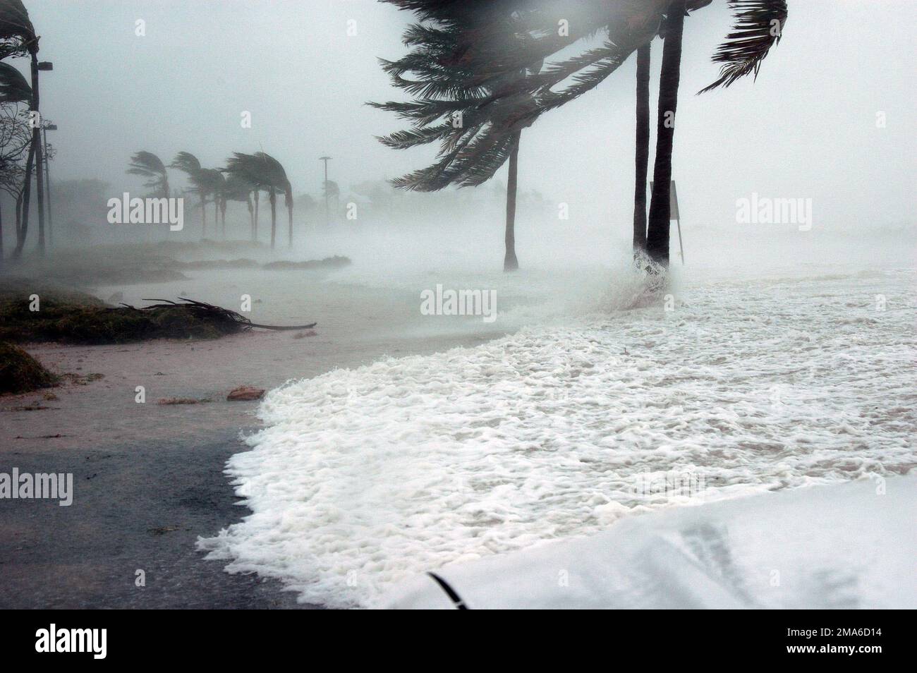 The Gulf of Mexico spills over an oceanfront road at Naval Air Station ...