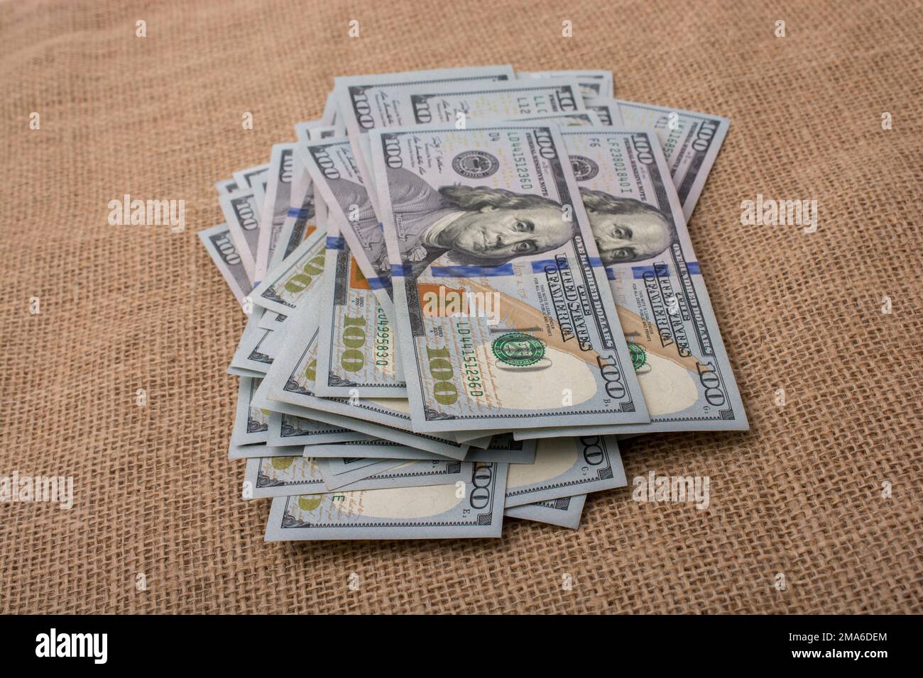 Banknote bundle of US dollar placed on a linen canvas Stock Photo - Alamy