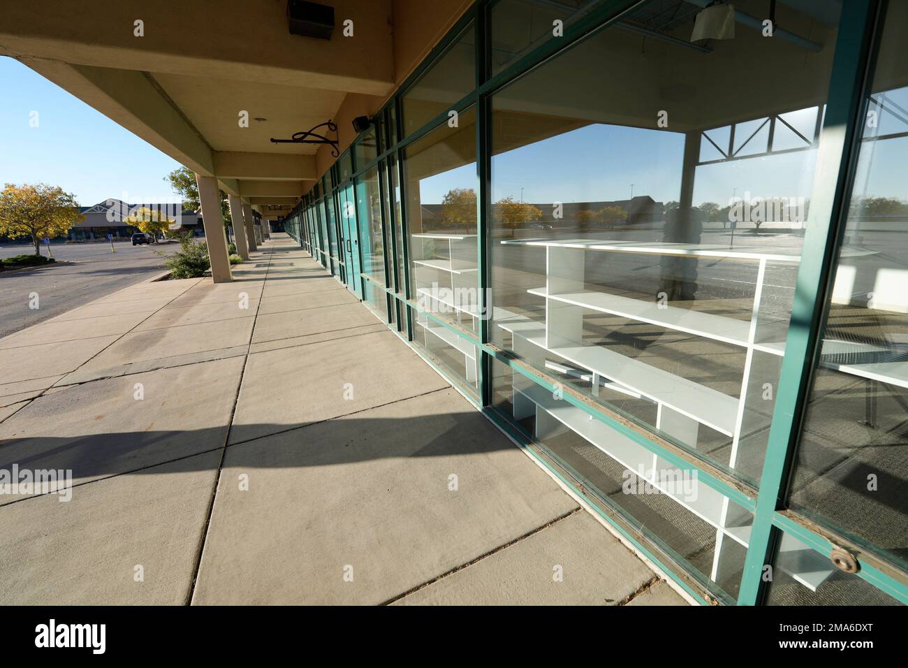 Empty walks pass by empty storefronts in the Outlets at Loveland Monday ...