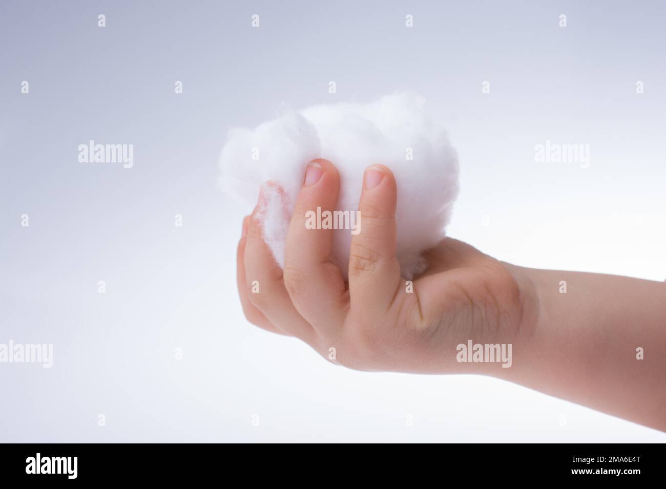 Hand holding some cotton in hand on a white background Stock Photo - Alamy