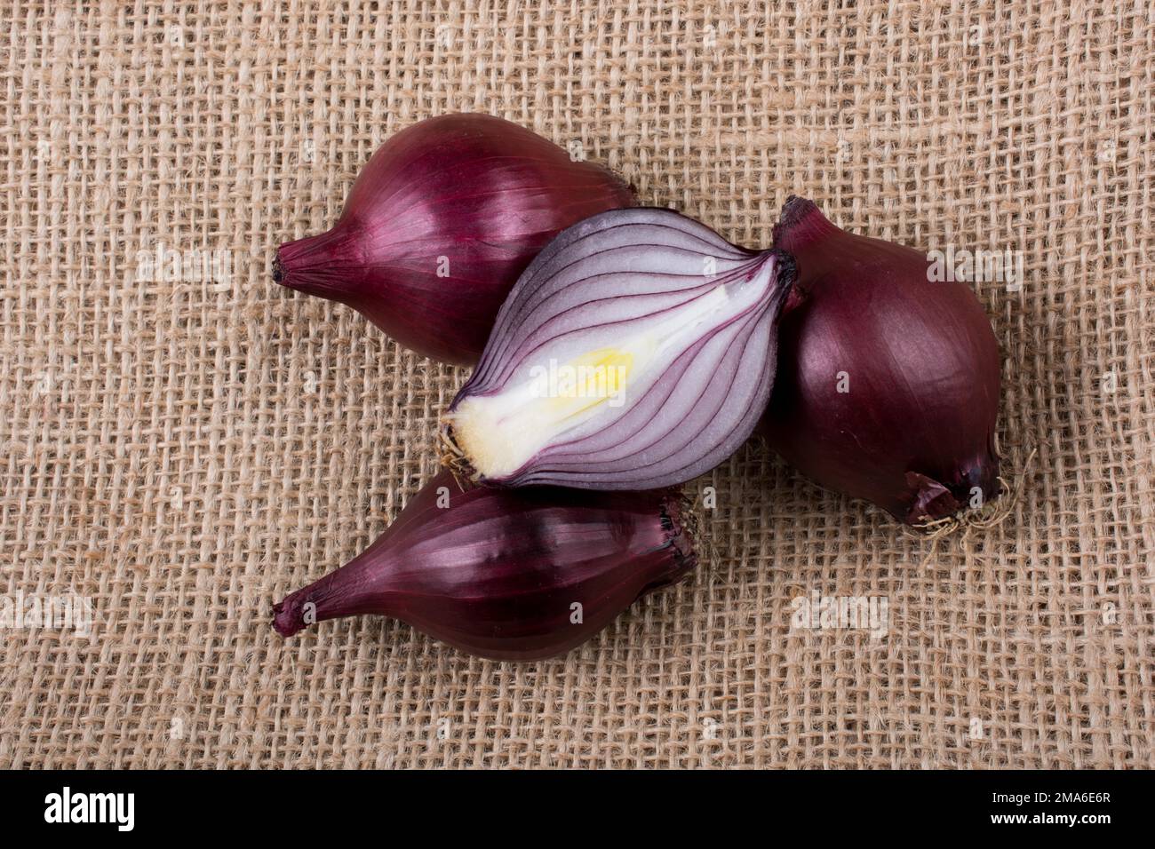 Red onion bulb cut in half on a certain background Stock Photo - Alamy