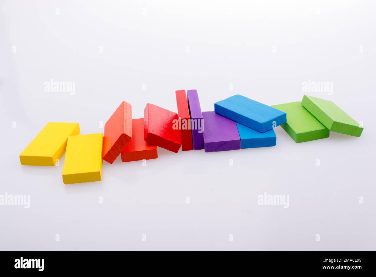 Colorful Domino Blocks in a line on a white background Stock Photo - Alamy