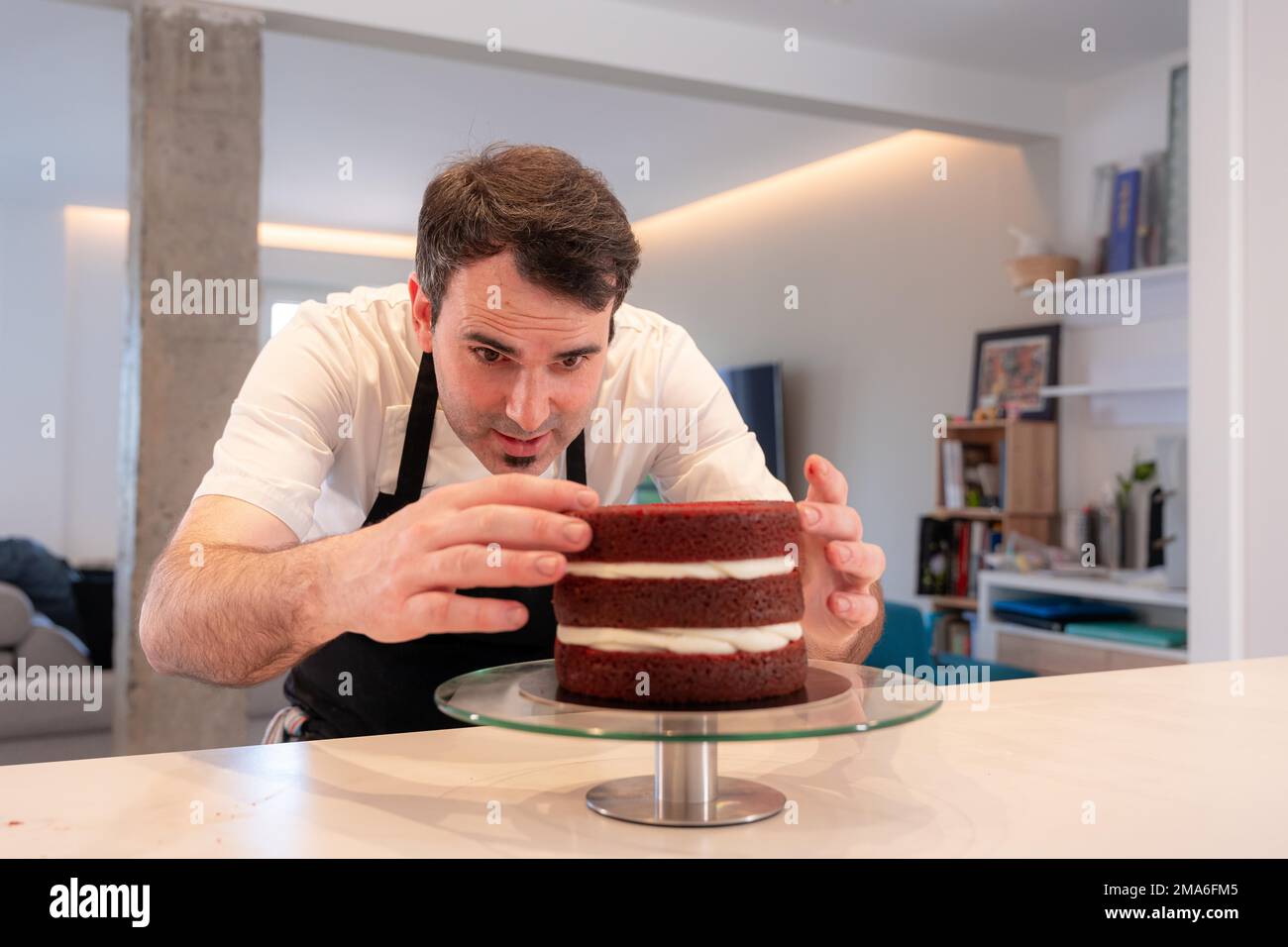 A challenger man bakes a red velvet cake at home, triple sponge base of ...