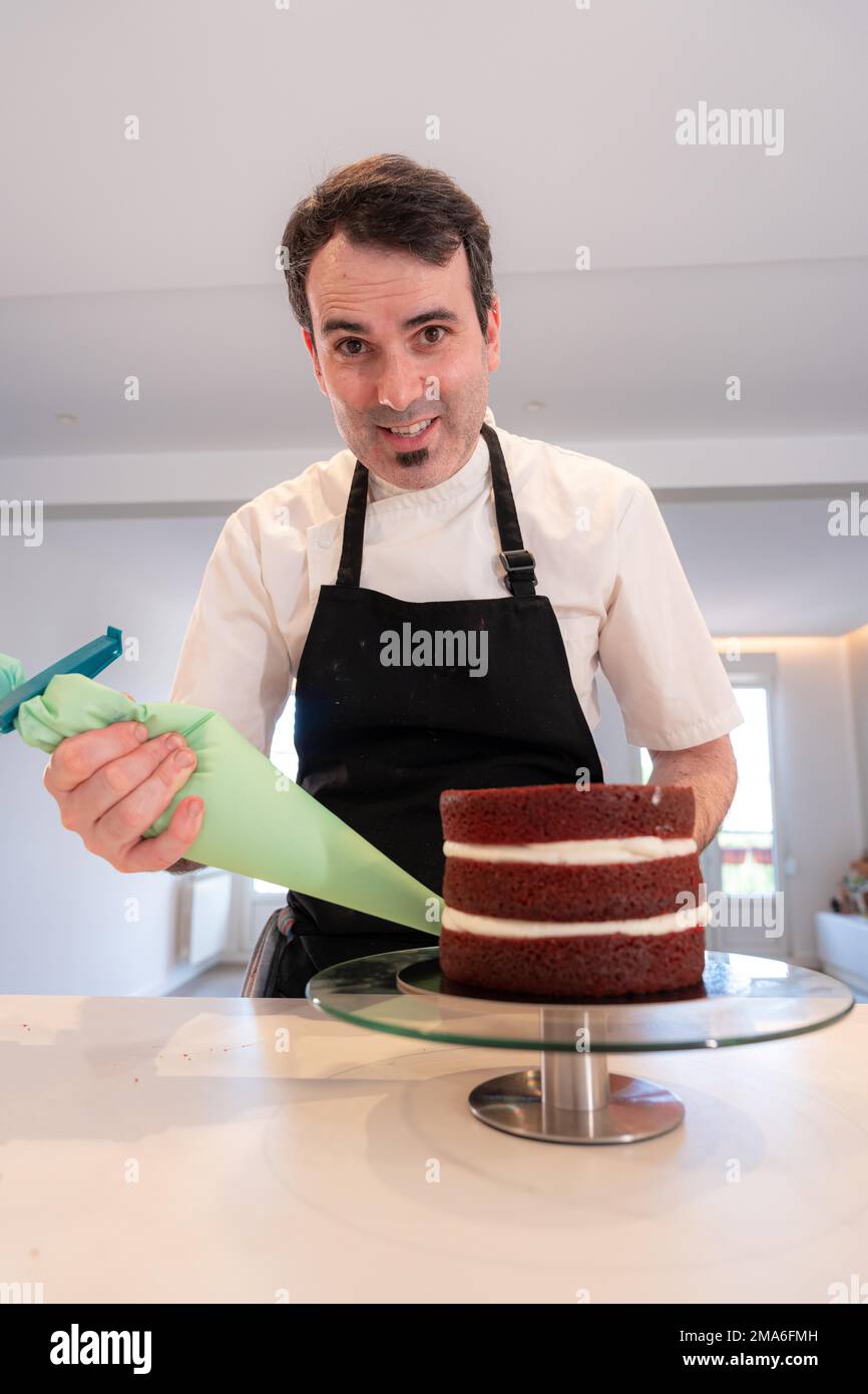 A challenger man bakes a red velvet cake at home, triple sponge base of ...