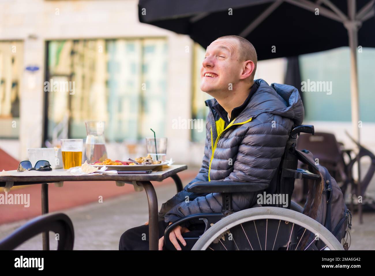 Portrait of a disabled person in a wheelchair in a restaurant ... Portrait of a disabled person in a wheelchair in a restaurant ...