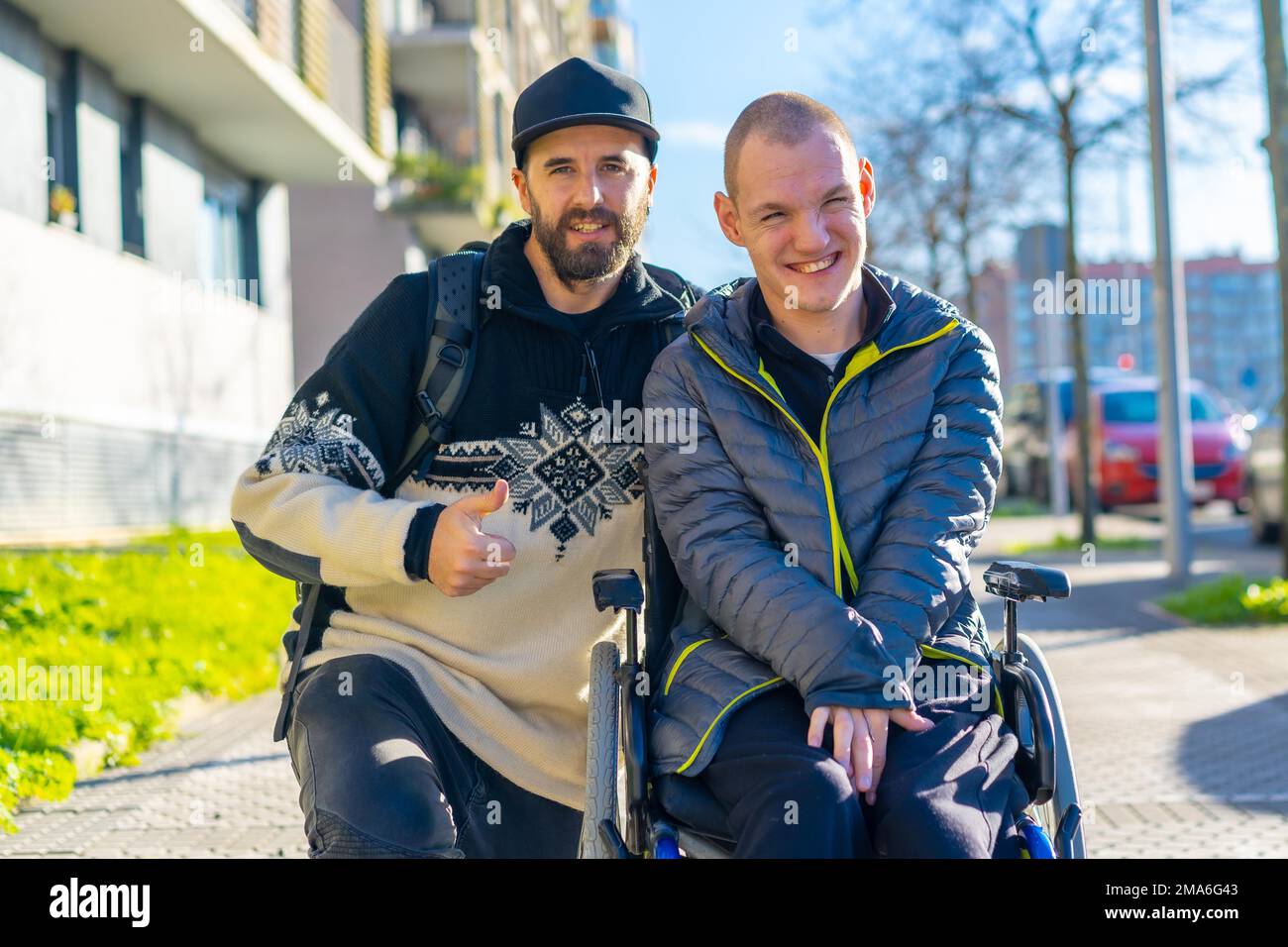 Portrait of a disabled person in a wheelchair with a friend, normality ...