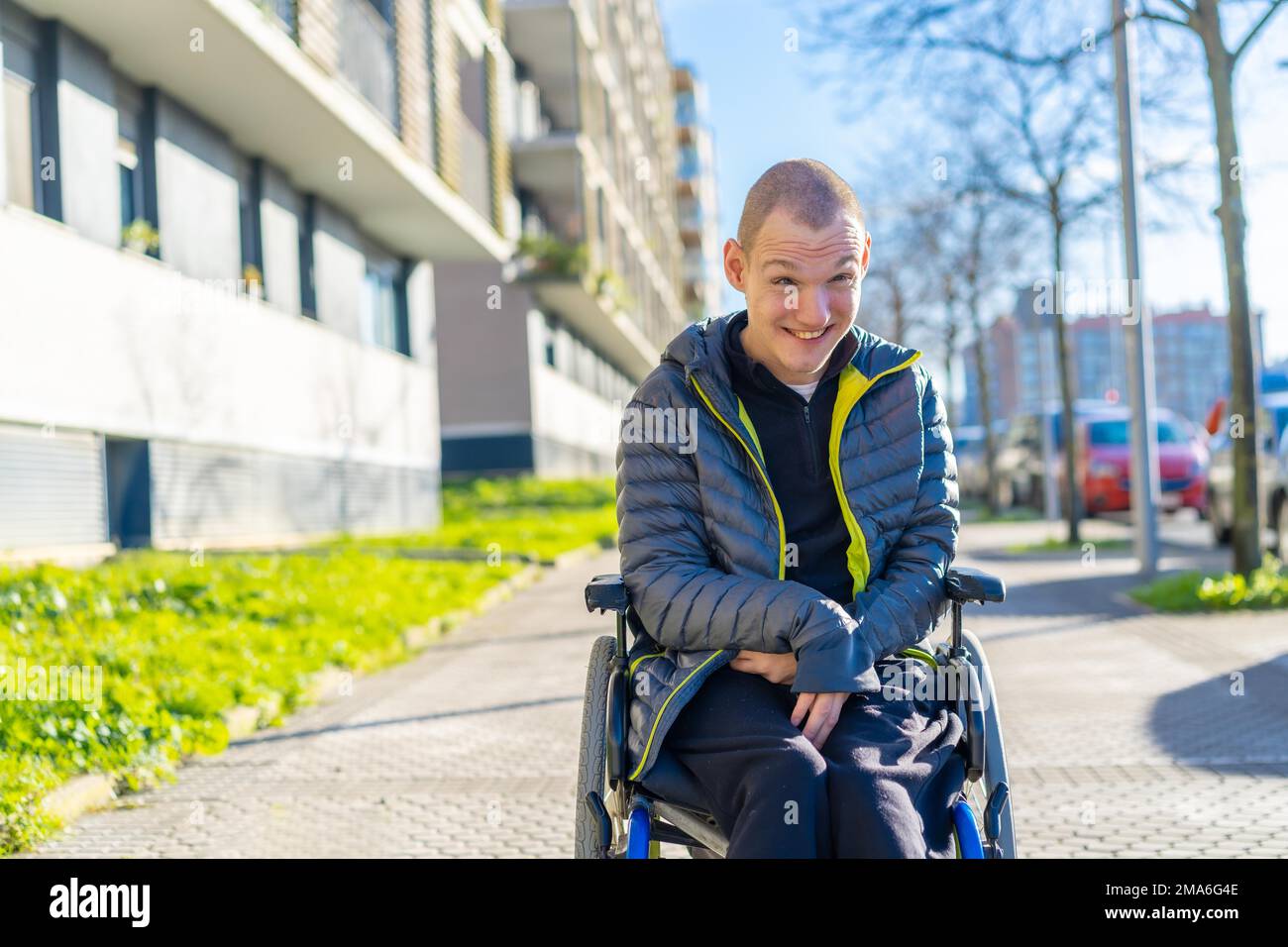 A disabled person having fun walking on the street in a wheelchair ...