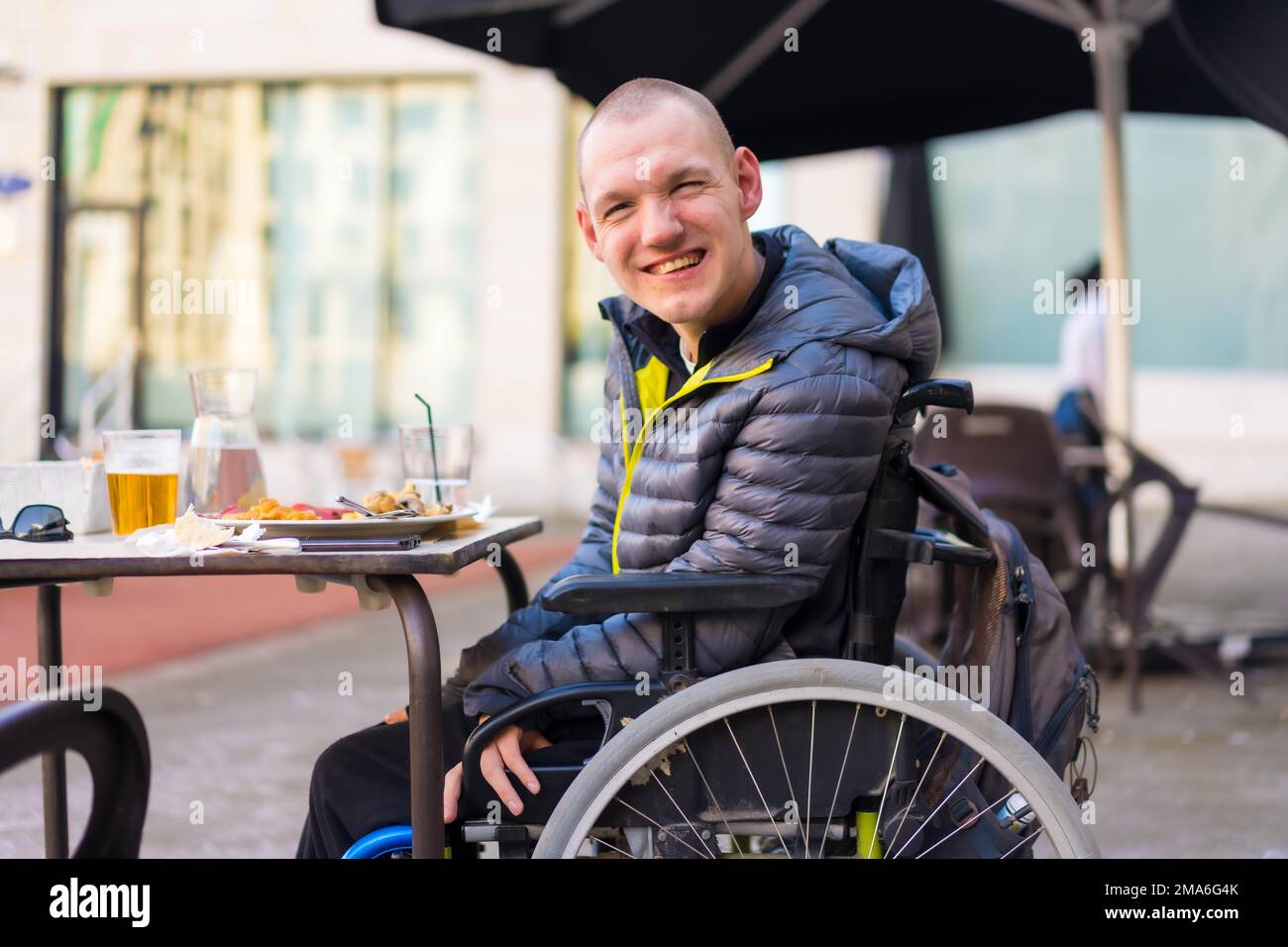 Portrait of a disabled person in a wheelchair in a restaurant ...