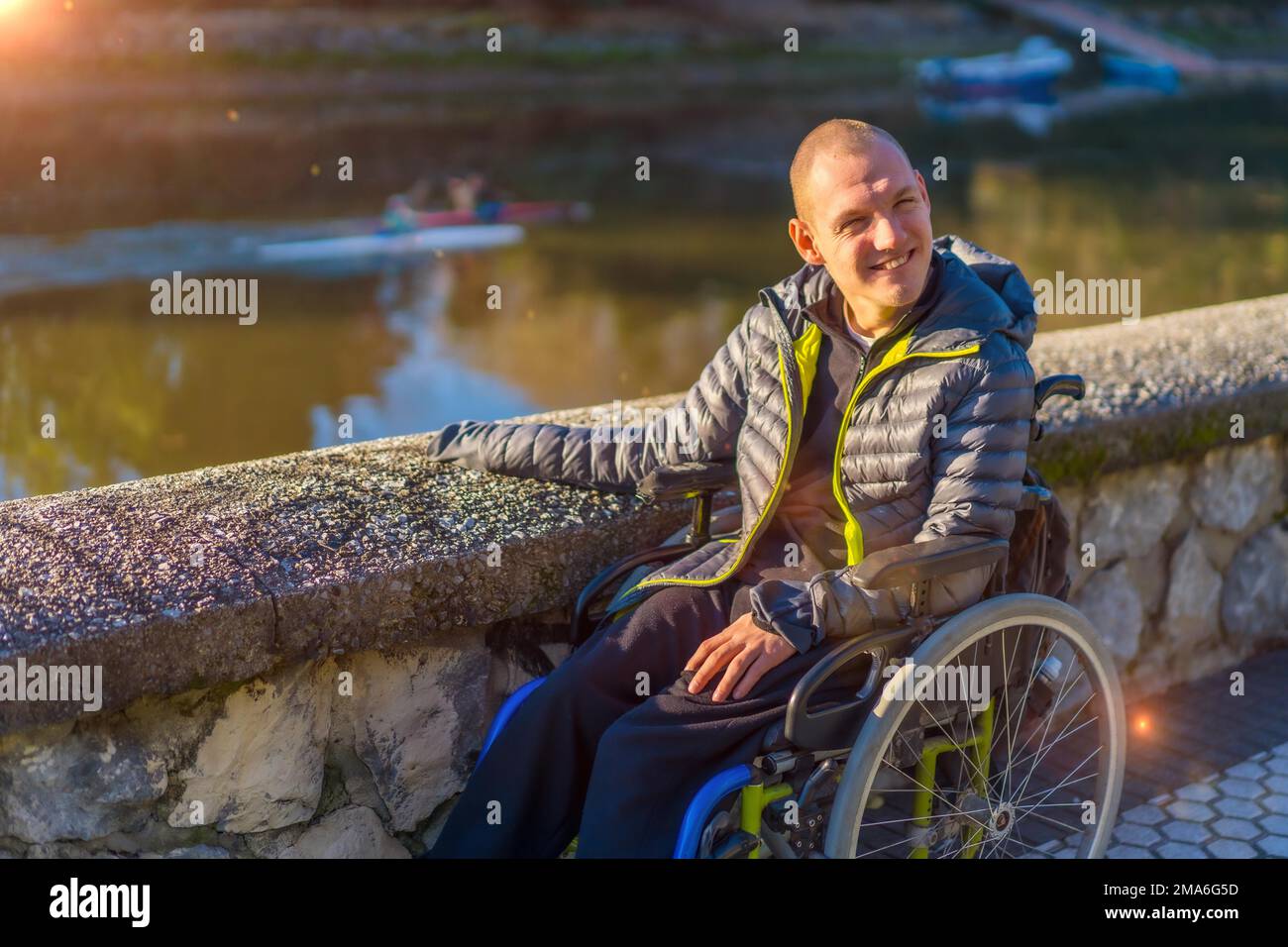 A disabled person in a wheelchair in a park at sunset smiling Stock ...