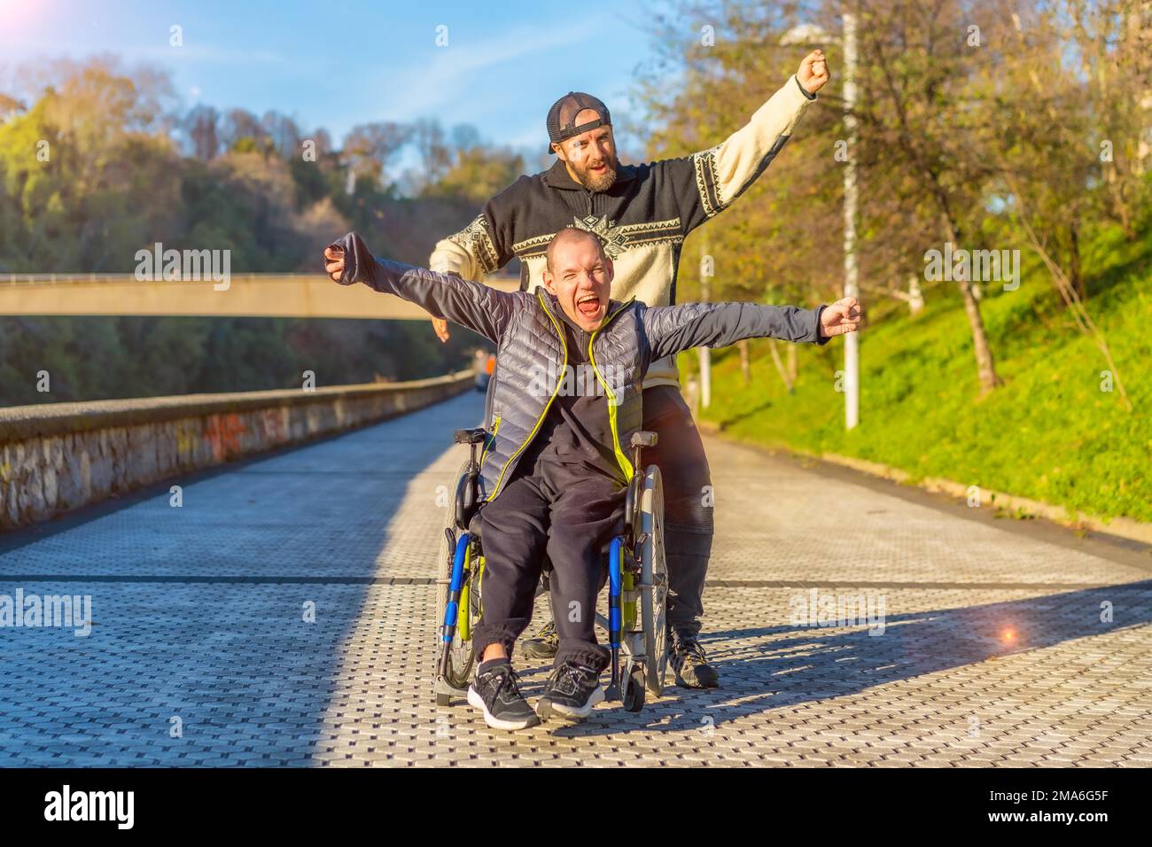 Disabled person in wheelchair with friend overjoyed, smiling, enjoying ...
