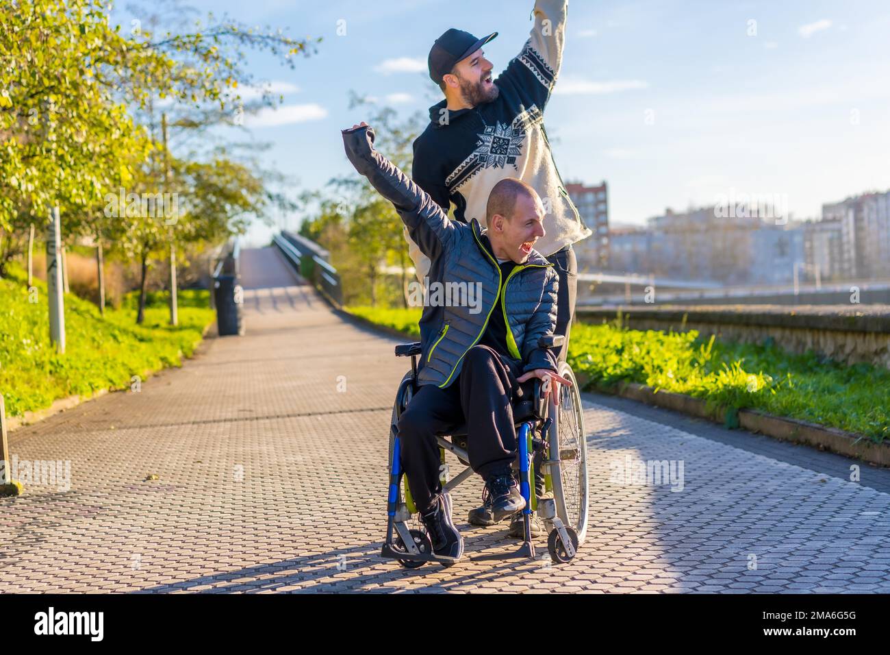 Disabled person in wheelchair with friend overjoyed, smiling, enjoying ...