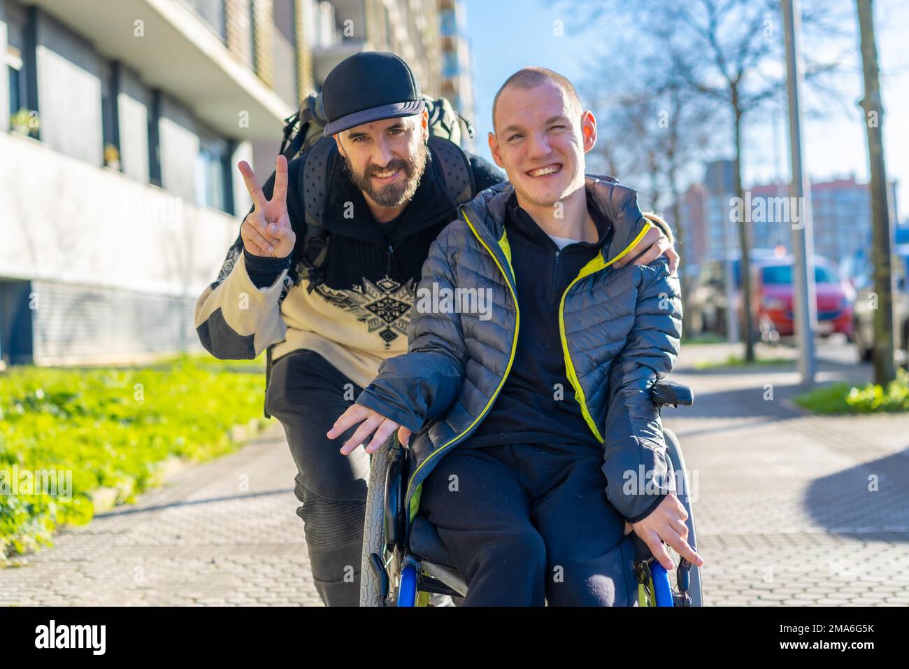 Portrait of a disabled person in a wheelchair with a friend, normality ...