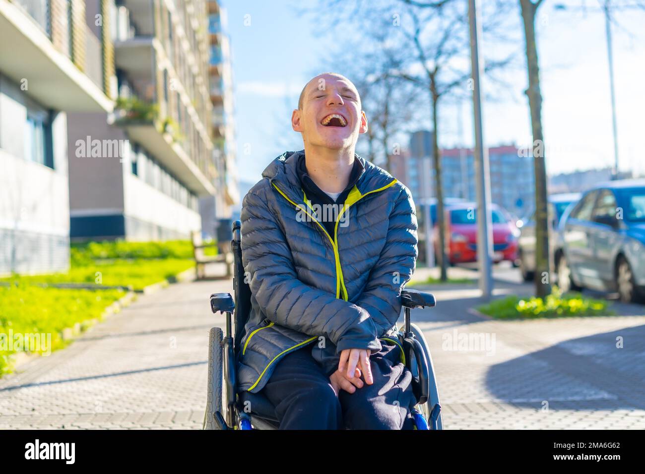 A disabled person enjoying walking on the street in a wheelchair ...