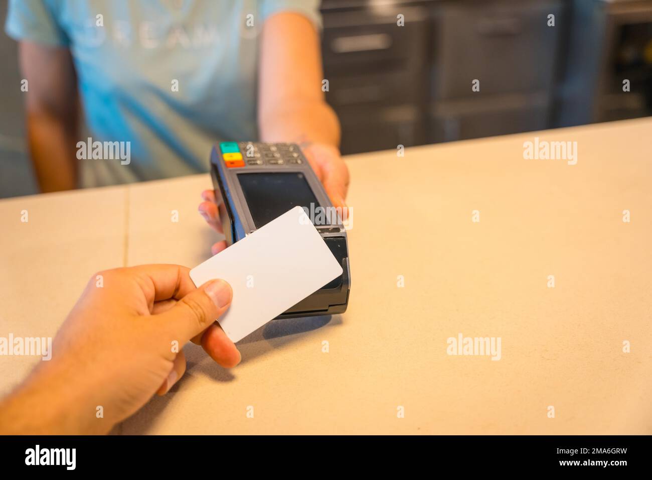 Unrecognizable waitress handing over the dataphone to collect with the ...