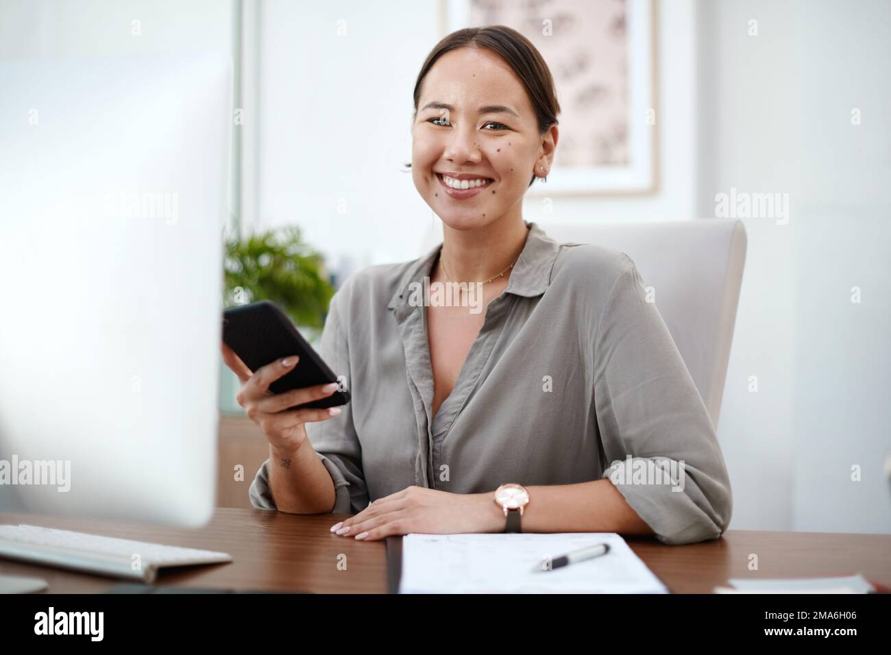 Getting positive feedback makes my day. a young businesswoman using her ...