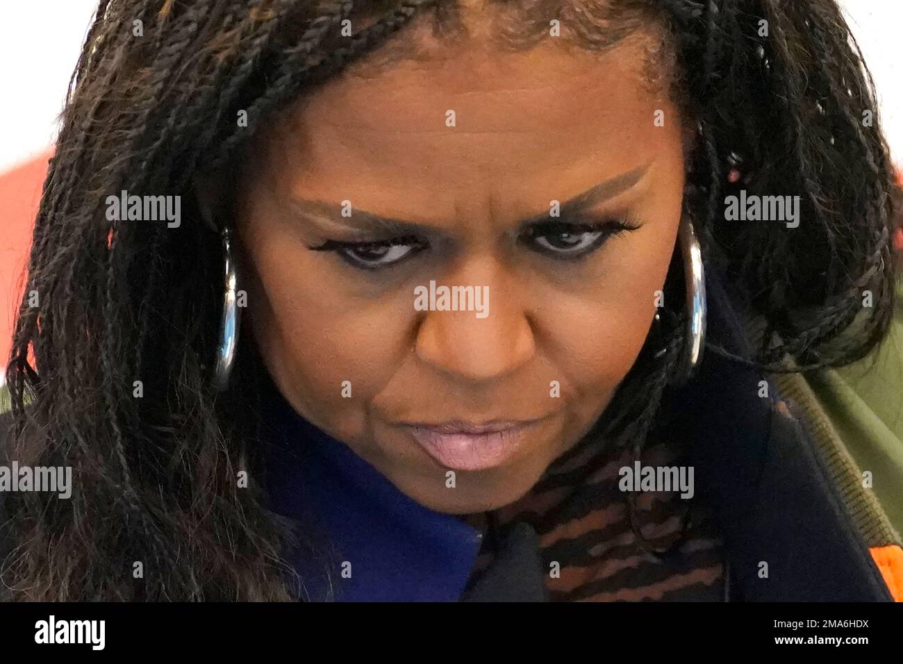 Former first lady Michelle Obama studies her ballot as she casts her ...