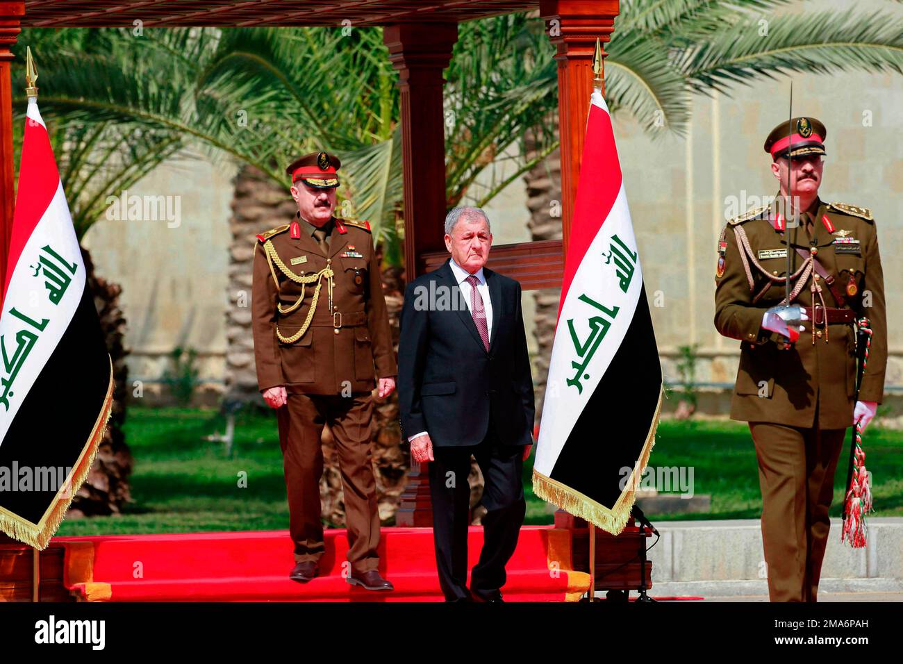 Newly elected Iraqi President Abdul Latif Rashid, center, inspects an ...