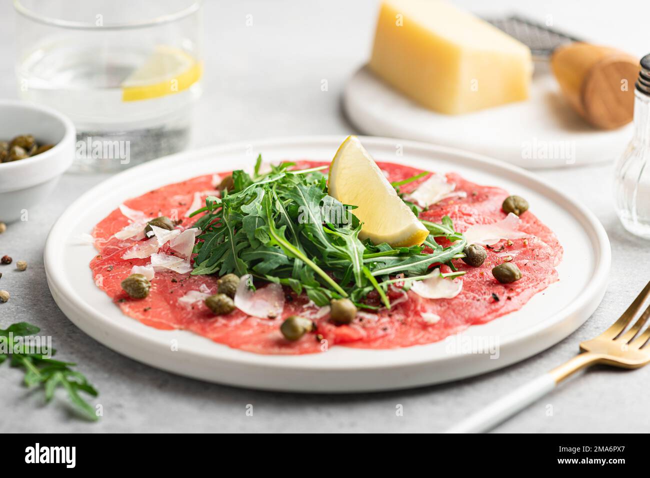 Beef carpaccio with capers, arugula and parmesan Stock Photo - Alamy